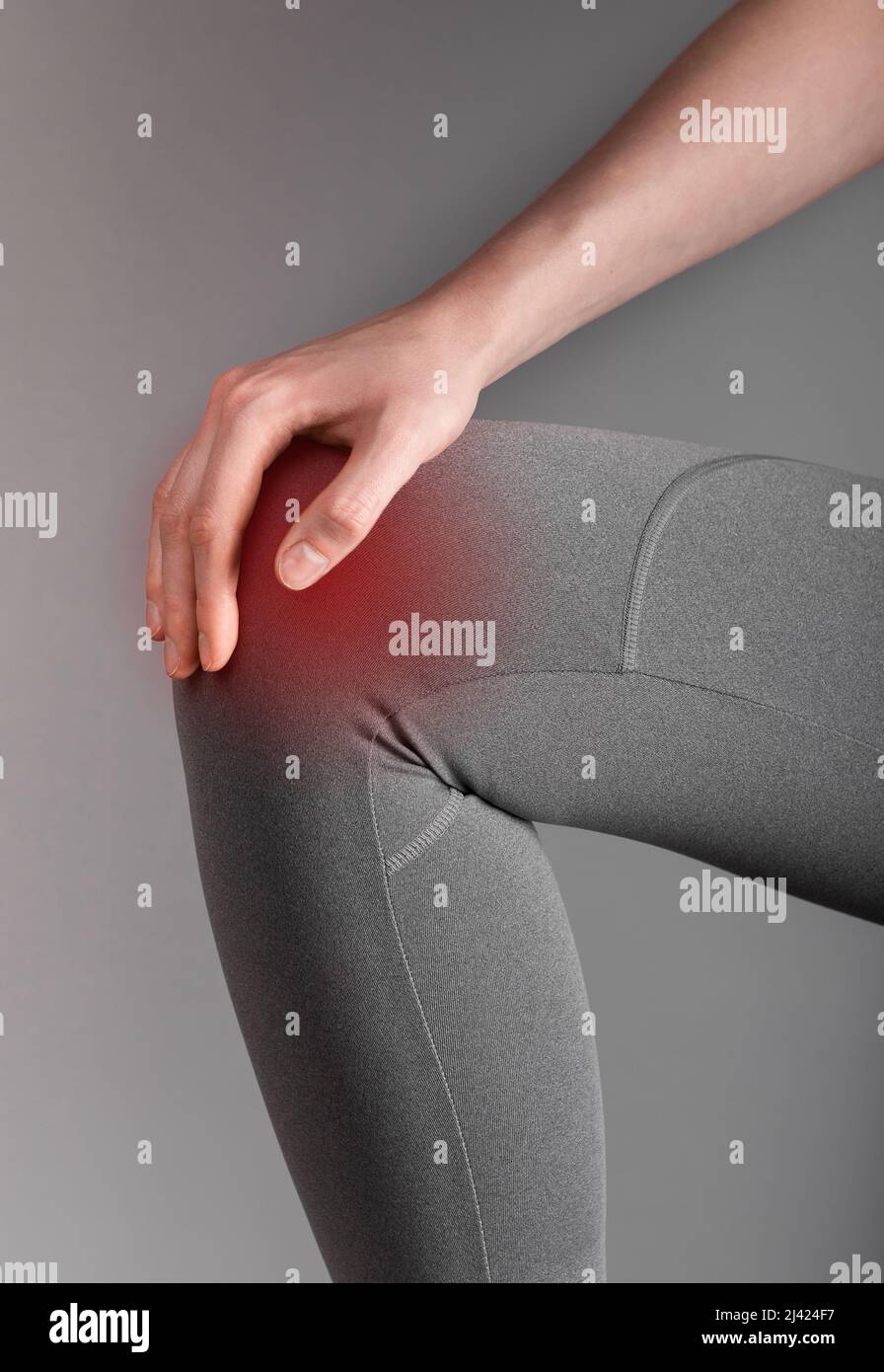 Knee pain. Woman suffering from ache in leg with red spot closeup ...