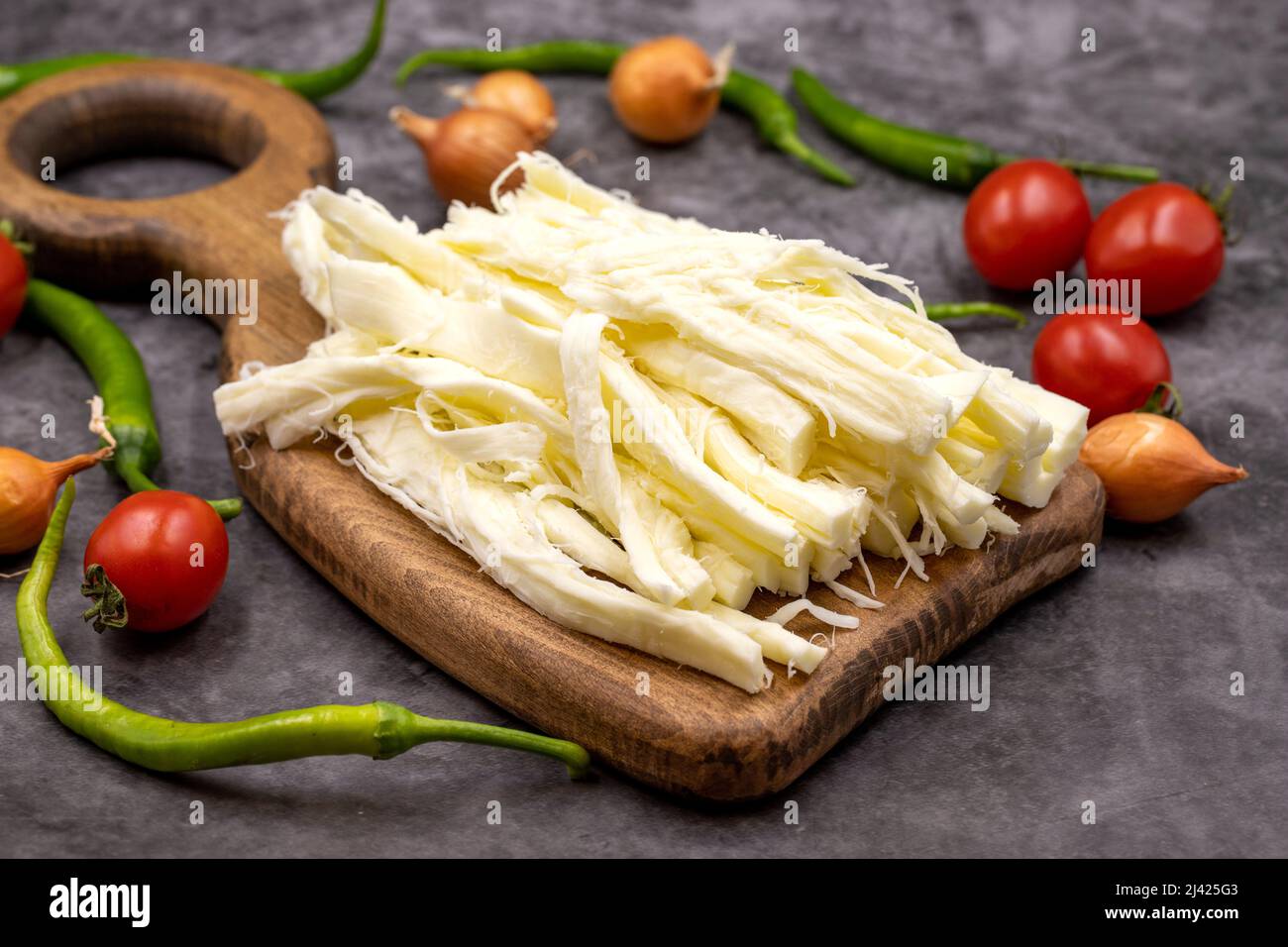 Cecil cheese or String cheese on a dark floor. Delicious assortment of ...