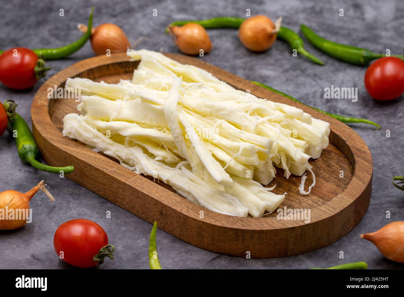 Cecil cheese or String cheese on a dark floor. Delicious assortment of ...