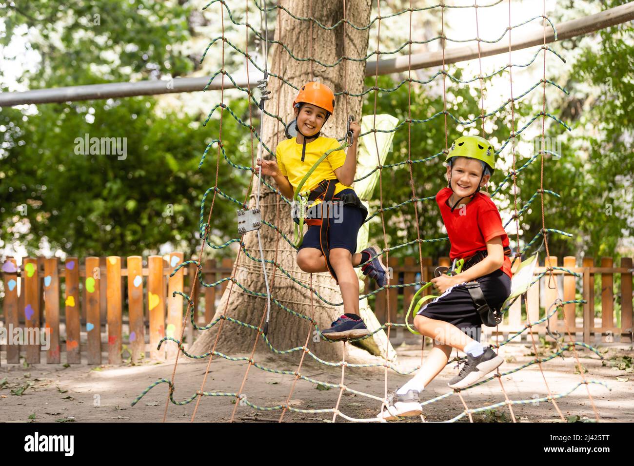 Happy child climbing in the trees. Rope park. Climber child. Early ...