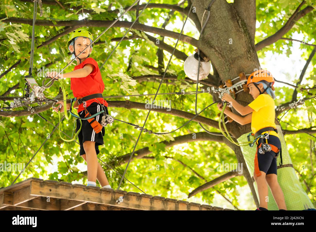 Boy climber walks on the rope bridge Stock Photo - Alamy