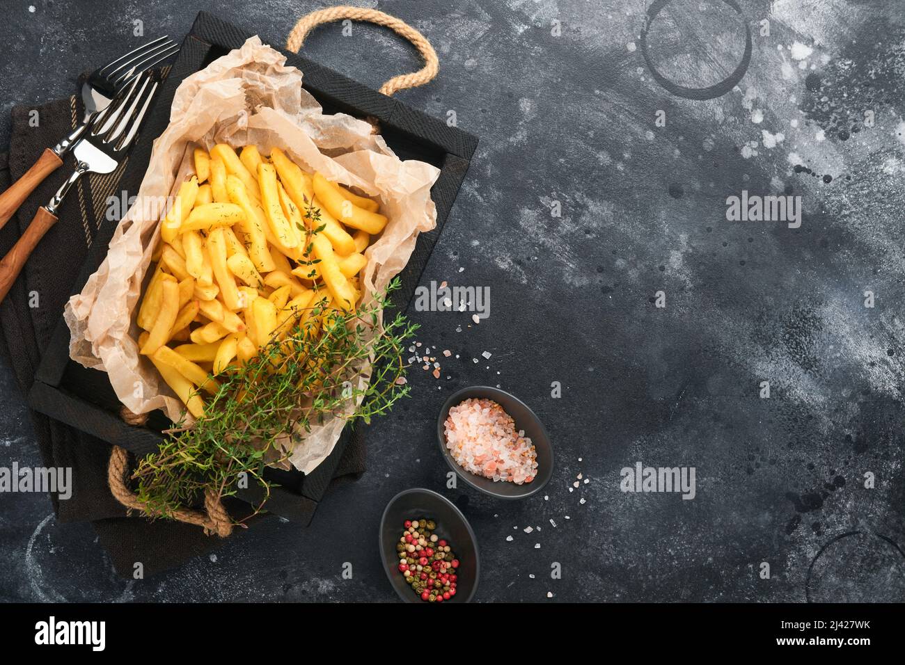 French fries. Tasty French fries server on parchment paper on wooden ...