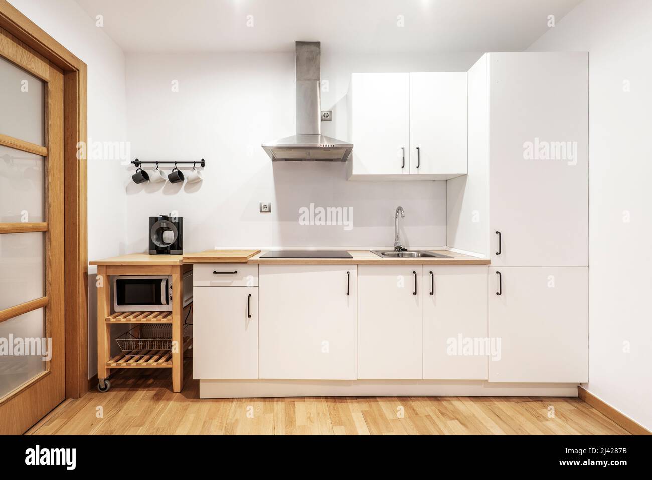 Kitchen front with combined furniture with wooden countertop and white ...
