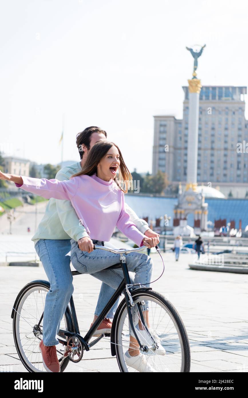 KYIV, UKRAINE - SEPTEMBER 1, 2021: Excited woman riding bike with ...