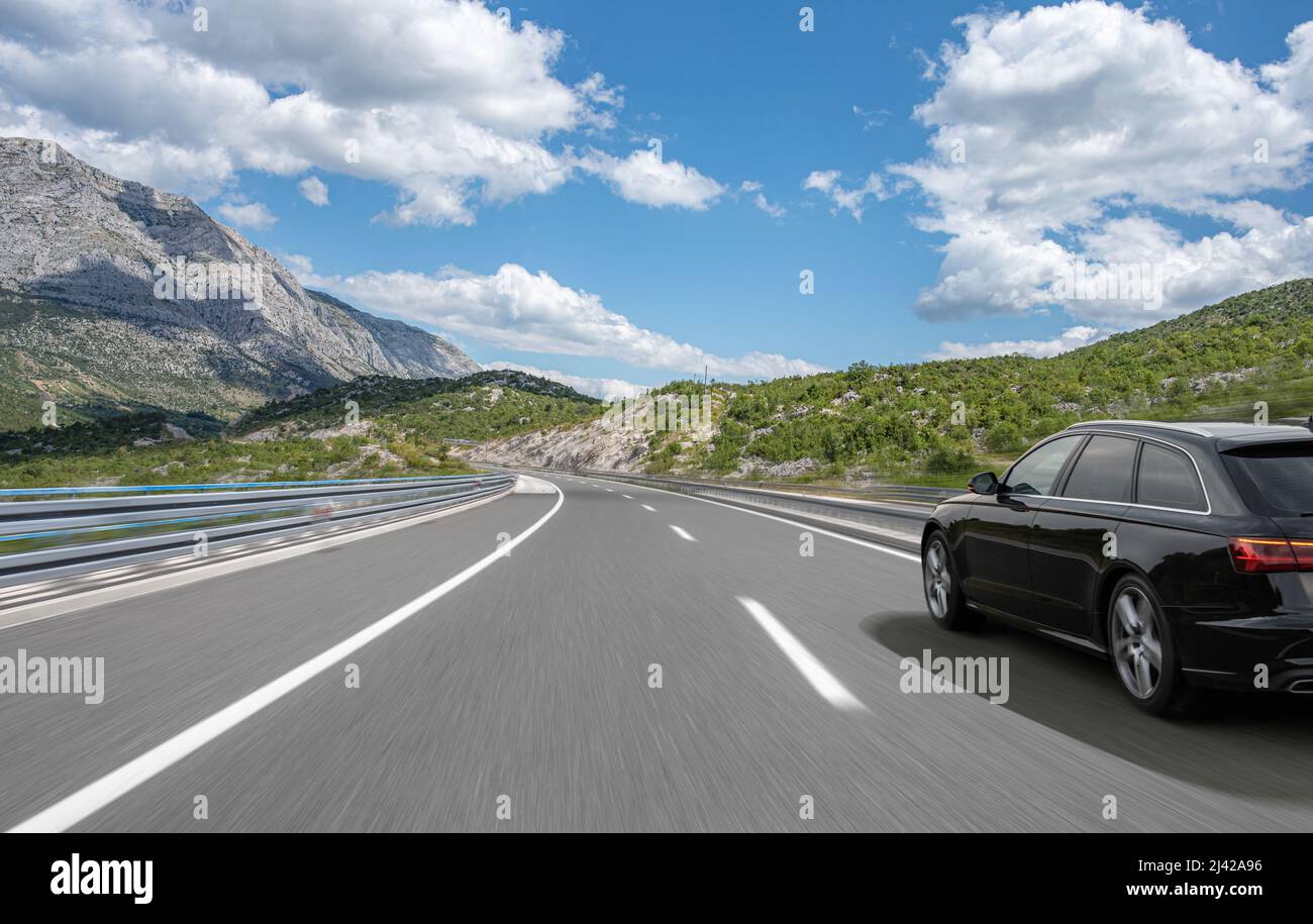 Car is driving along the road Stock Photo - Alamy
