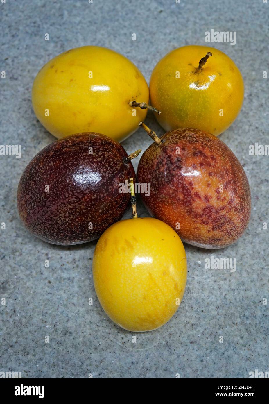 Passion fruits on granite background Stock Photo - Alamy