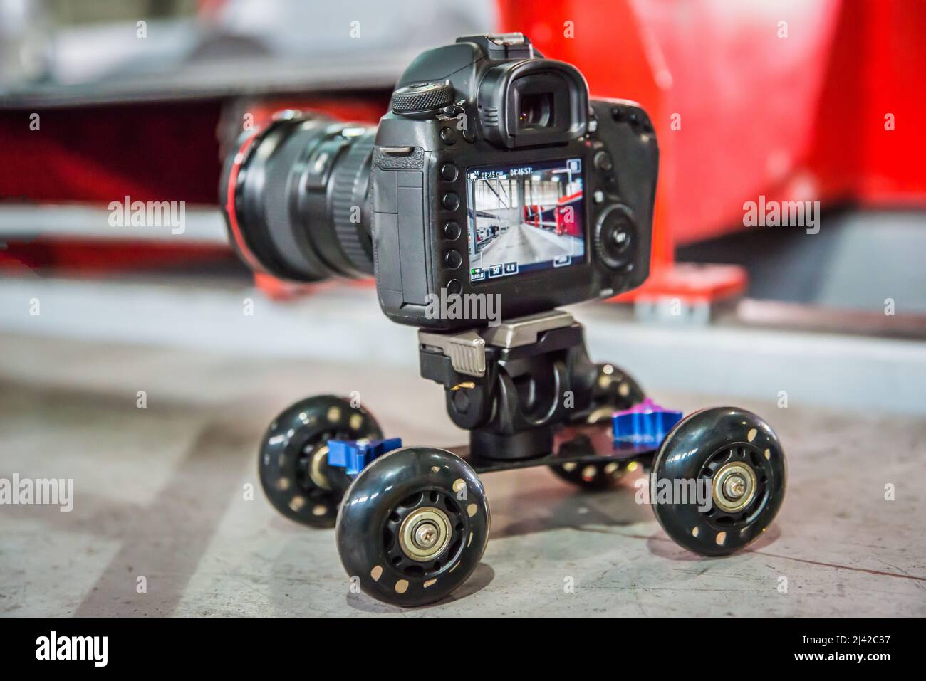 DSLR camera with monitor on mini table desktop rail wheel system making ...