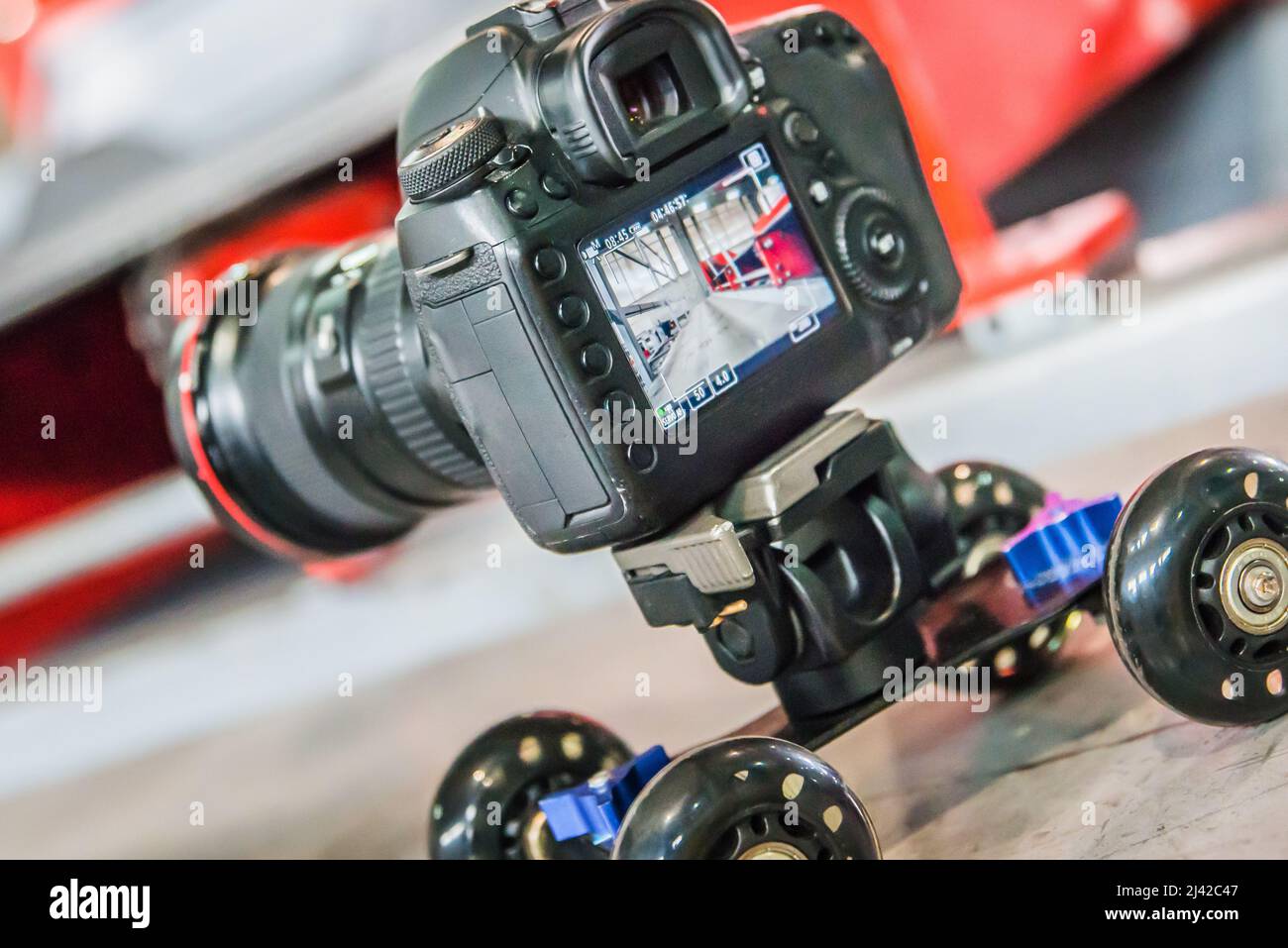 DSLR camera with monitor on mini table desktop rail wheel system making ...