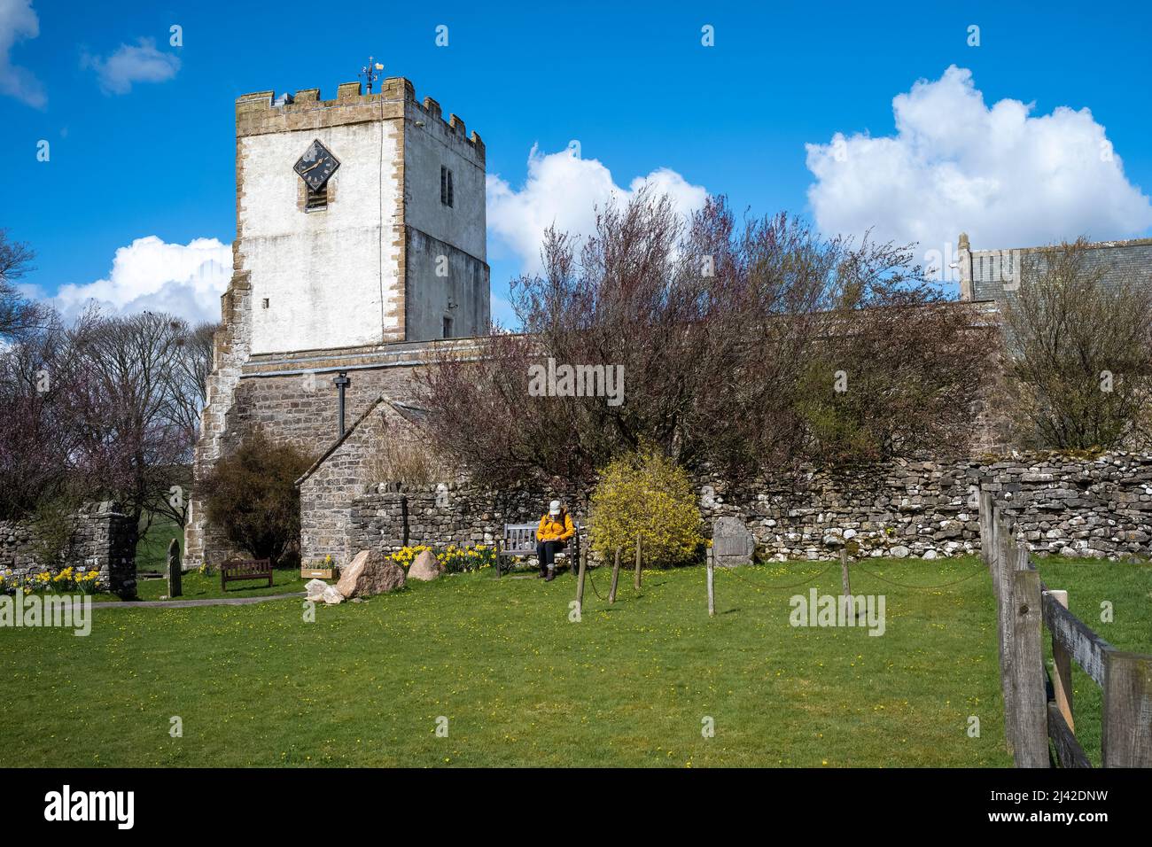 Resting and reading outside All Saints Church, Orton, Upper Lune Valley ...