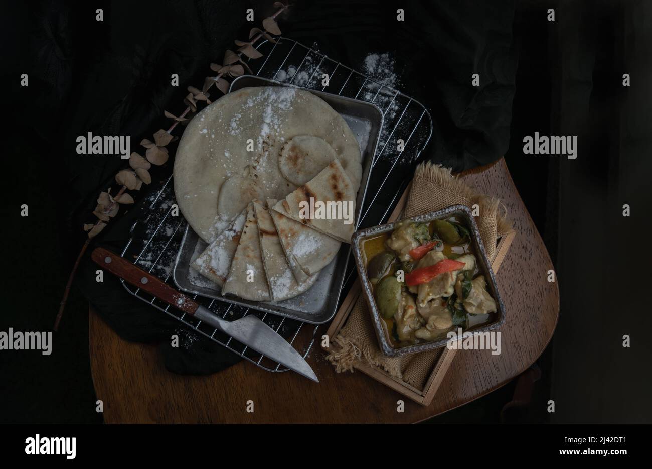 Homemade pita bread served with Green curry chicken (Kaeng khiao wan ...
