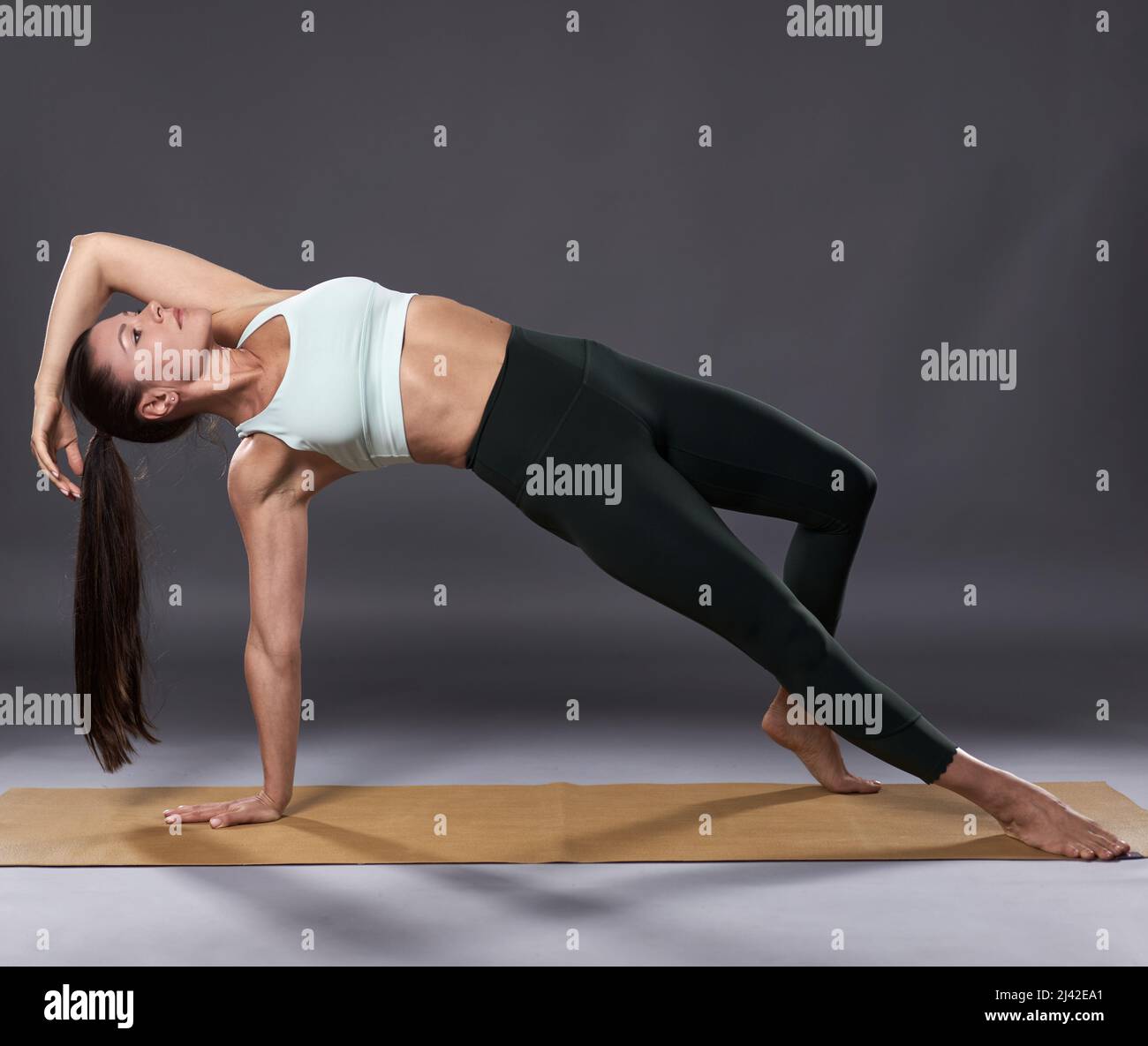 Woman yoga trainer doing Camatkarasana (Wild thing) pose Stock Photo ...