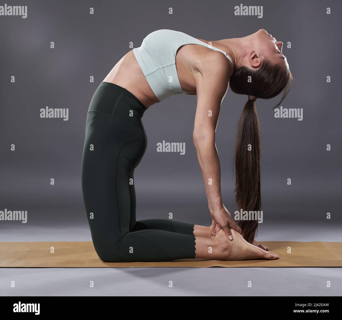 Woman yoga trainer doing the Ustrasana (camel) pose Stock Photo - Alamy