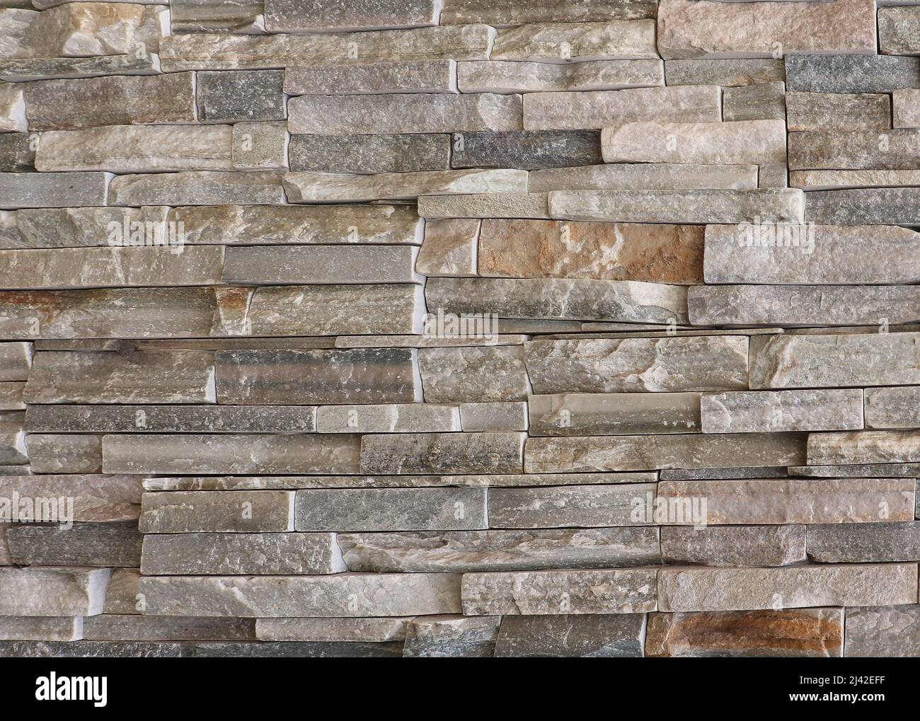 Grey and tan layered brick wall Stock Photo - Alamy