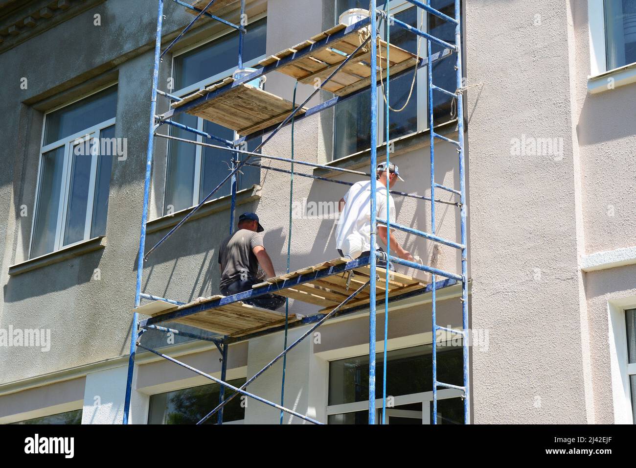 Rendering, applying stucco, and plastering the facade of the house. Two ...