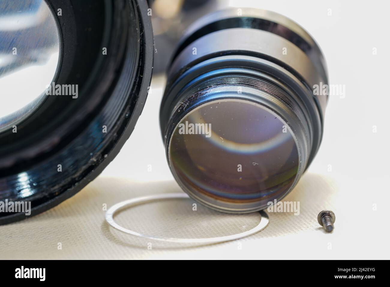Clean and disassemble the lens for photography into its component parts ...