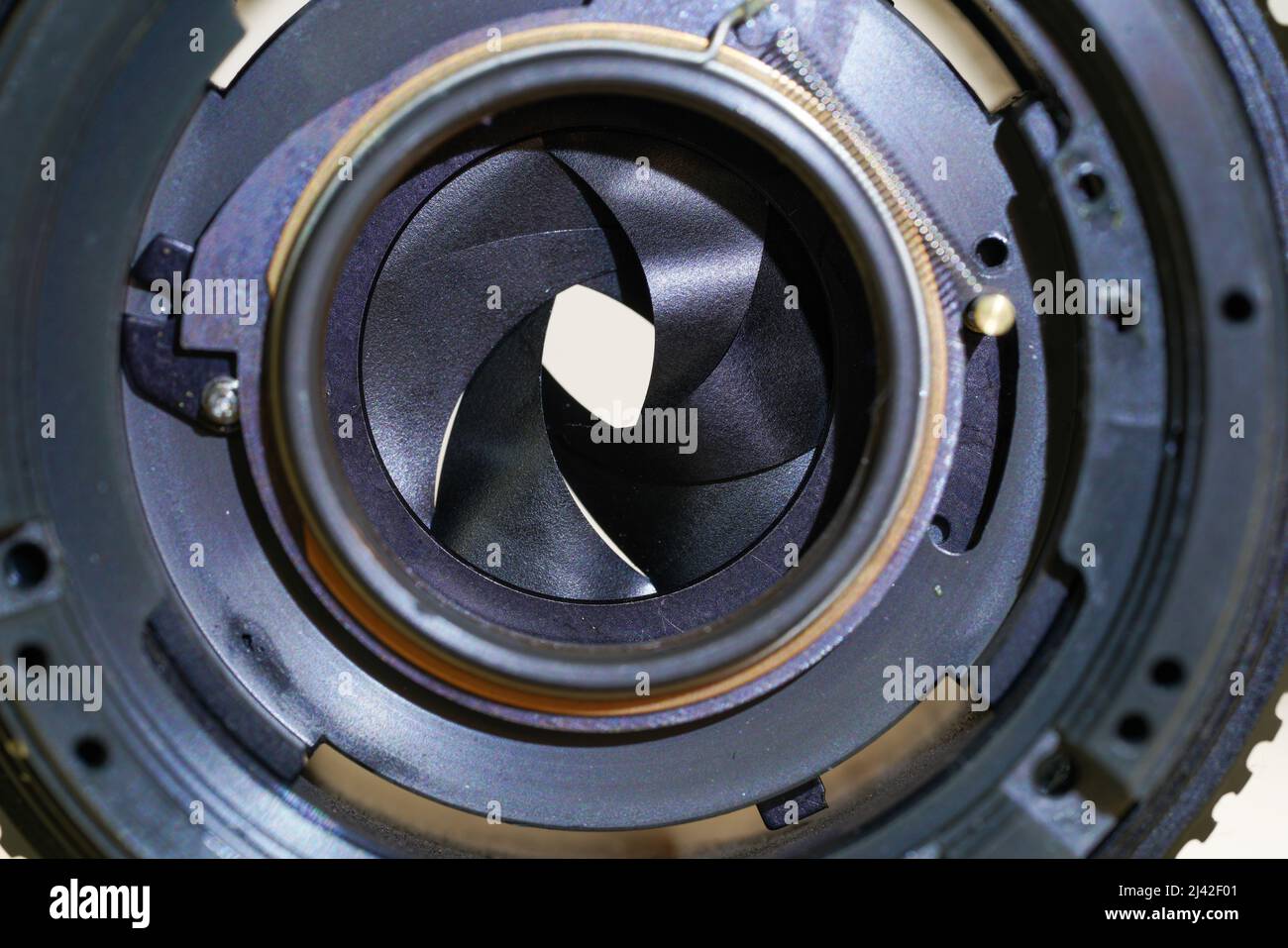 Clean and disassemble the lens for photography into its component parts ...