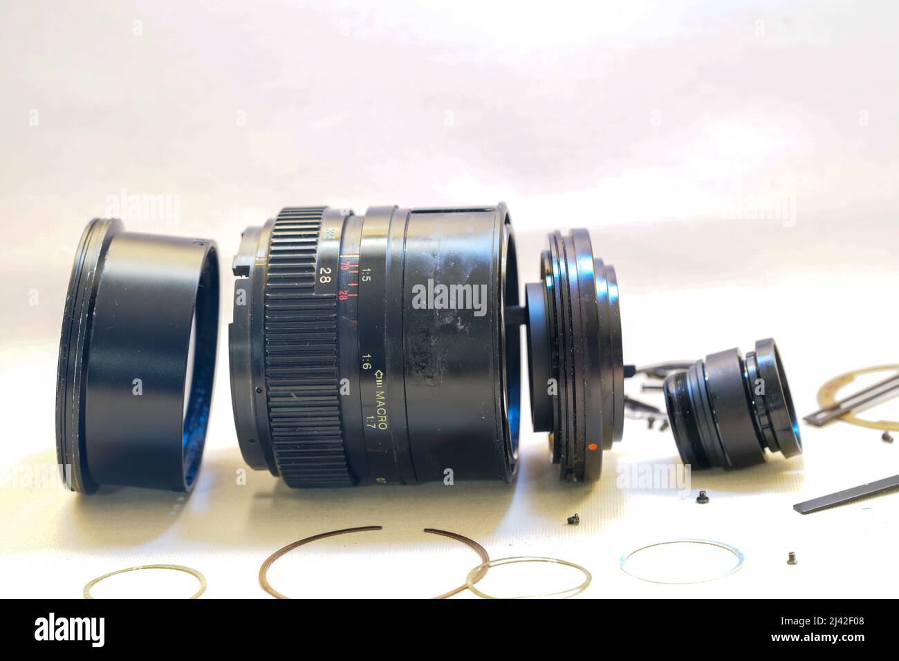 Clean and disassemble the lens for photography into its component parts ...