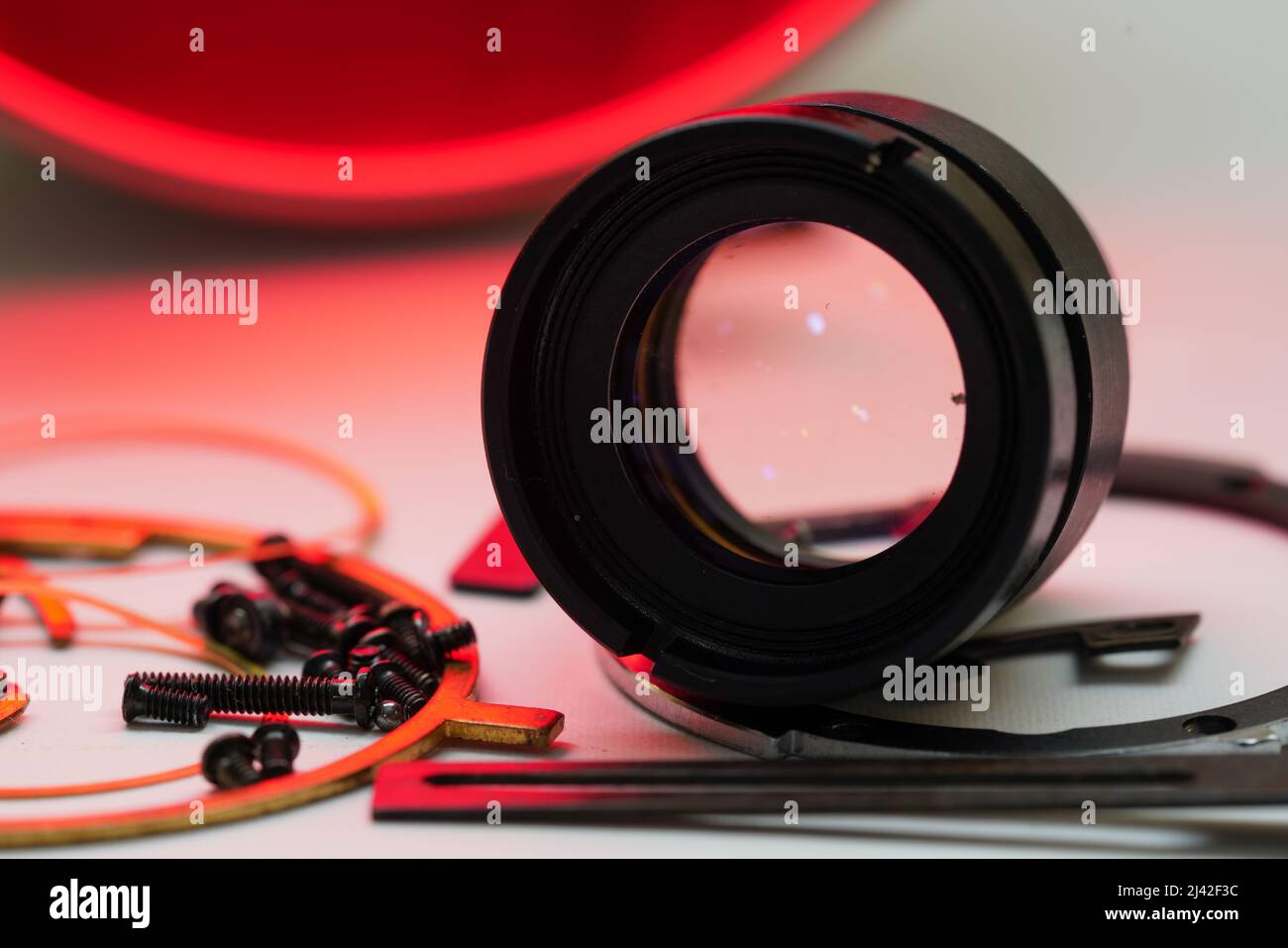 Clean and disassemble the lens for photography into its component parts ...
