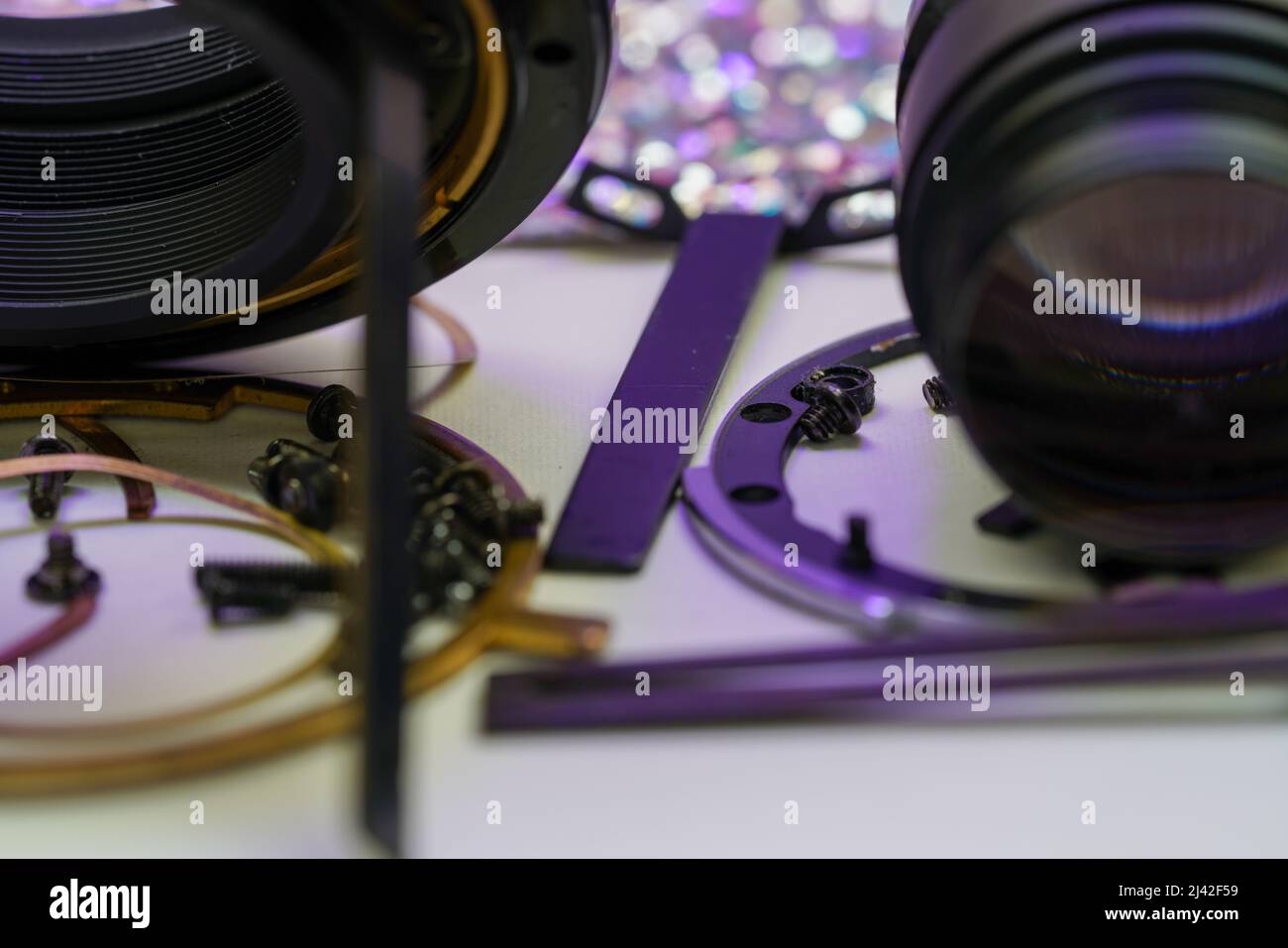 Clean and disassemble the lens for photography into its component parts ...