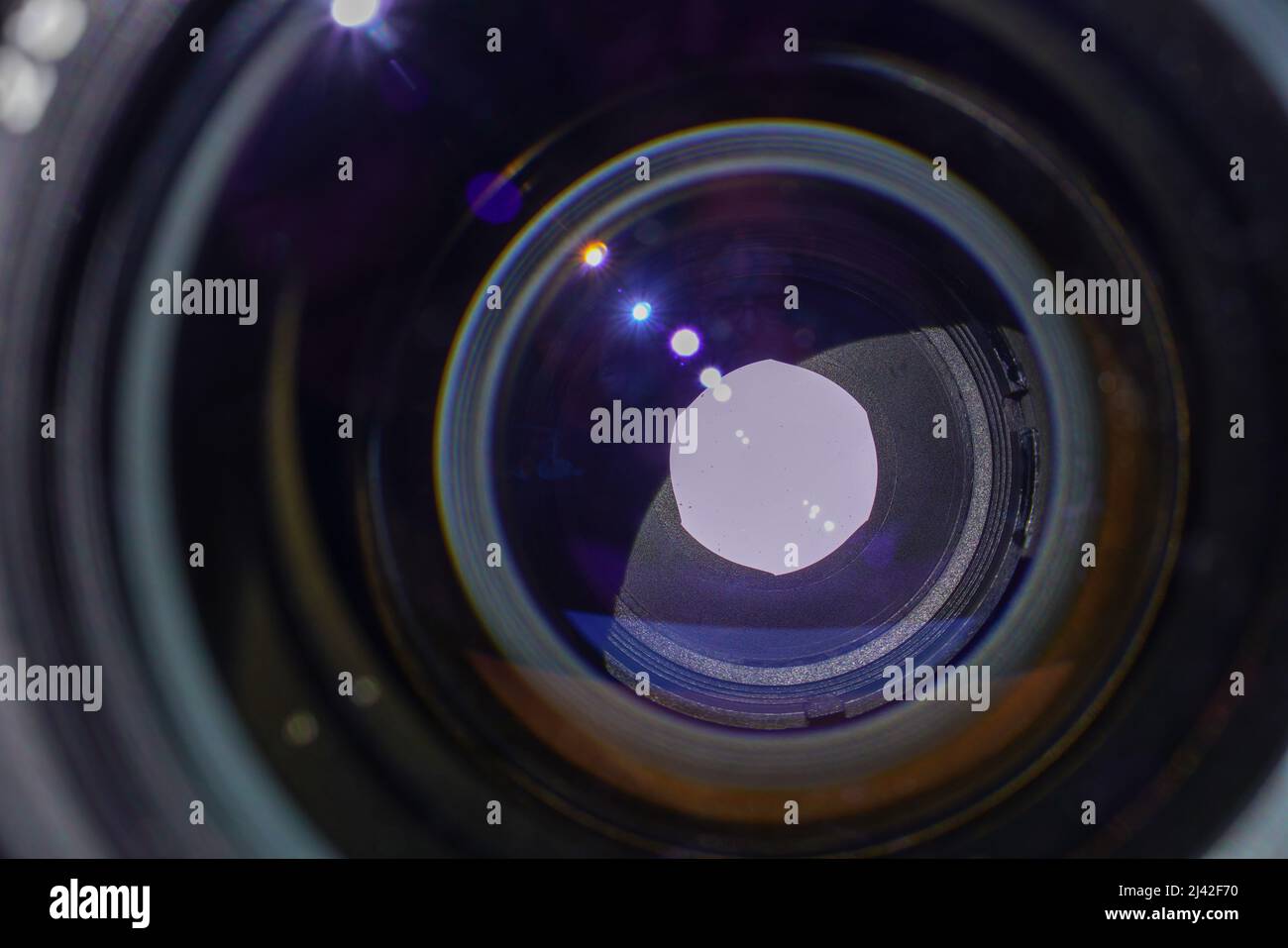 Clean and disassemble the lens for photography into its component parts ...