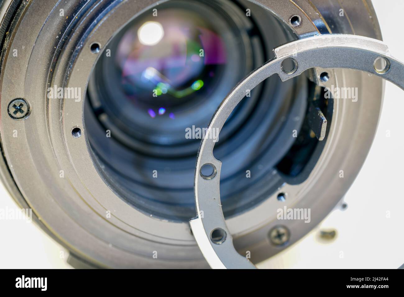 Clean and disassemble the lens for photography into its component parts ...