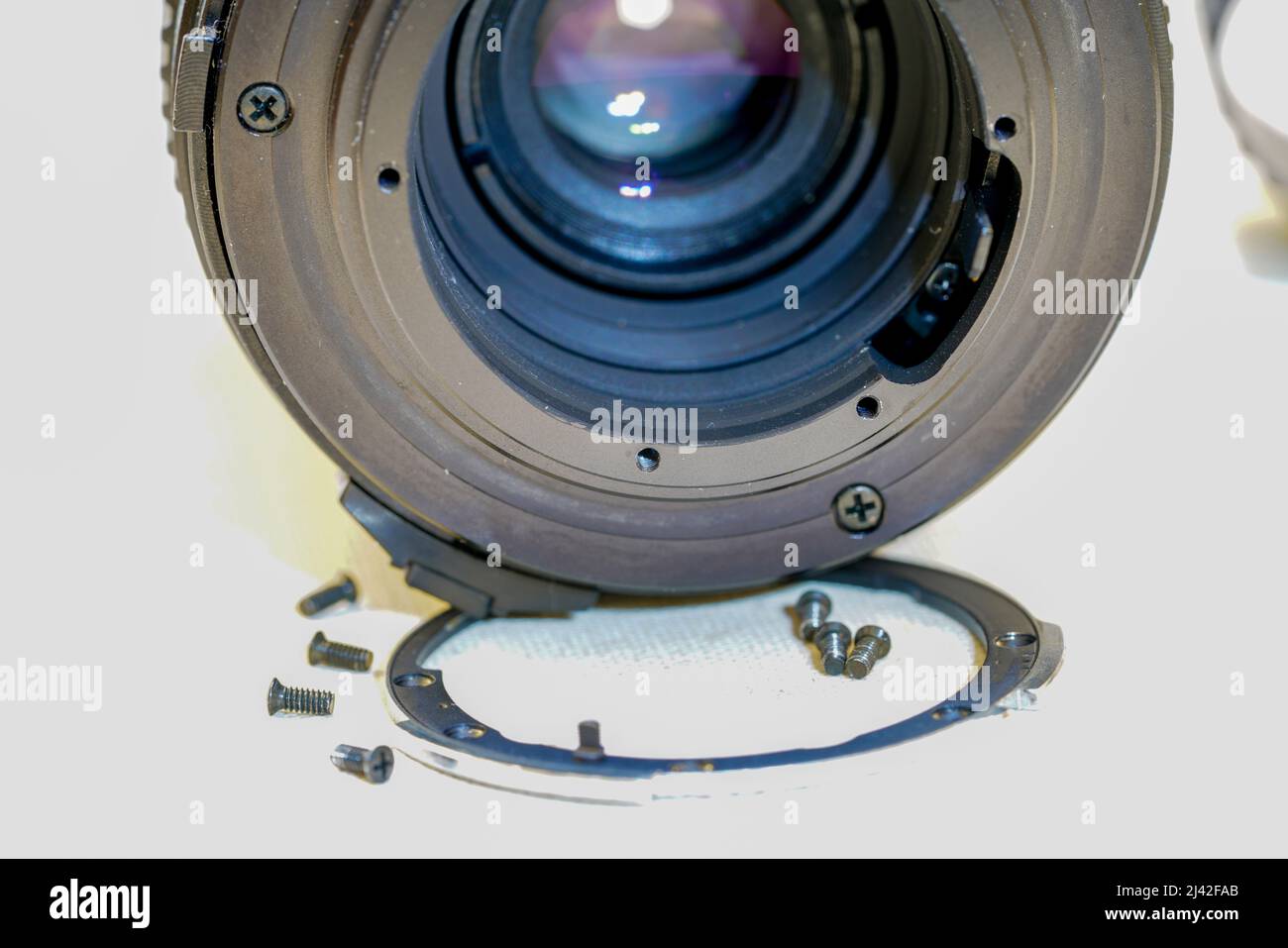 Clean and disassemble the lens for photography into its component parts ...