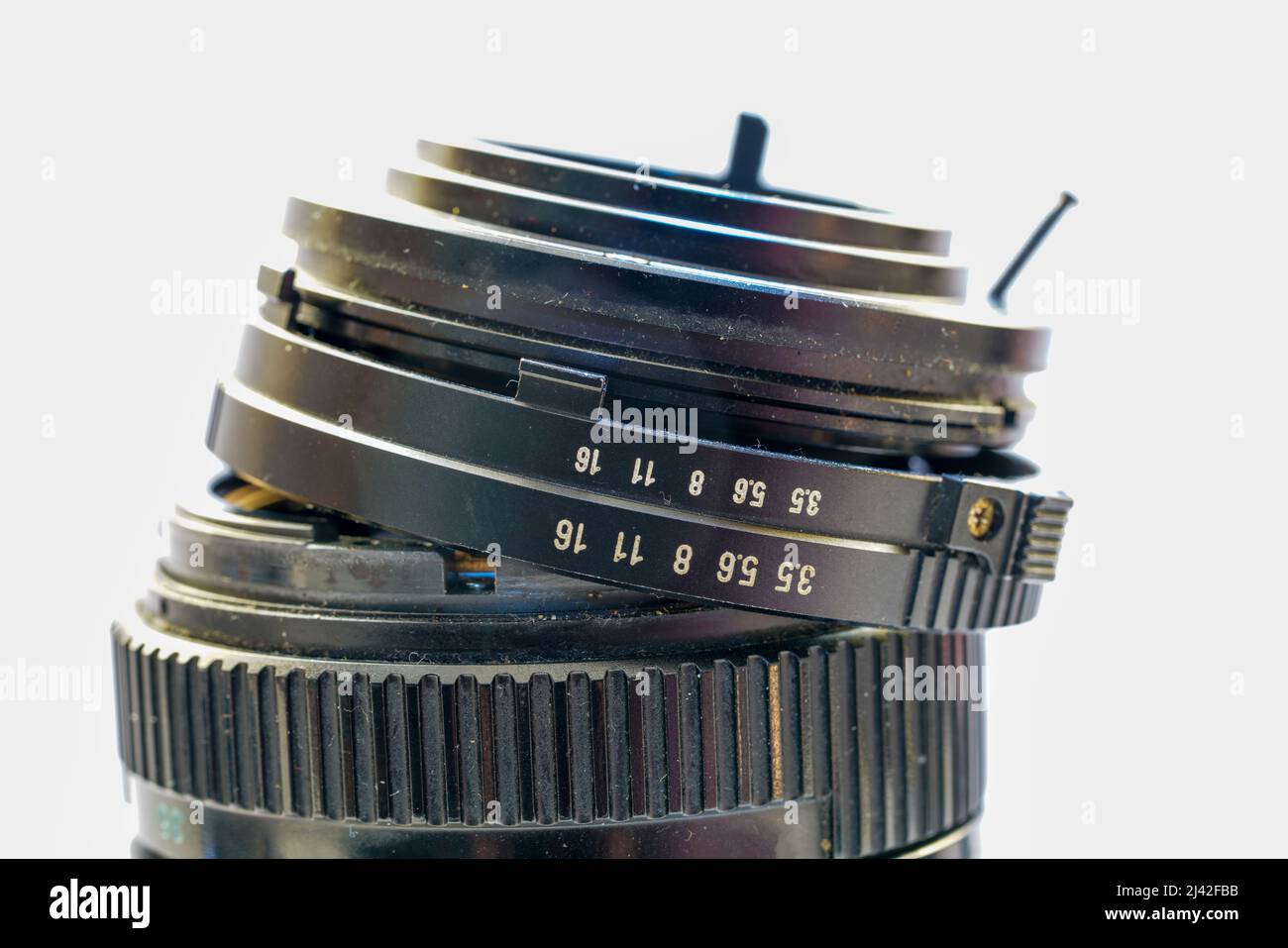 Clean and disassemble the lens for photography into its component parts ...