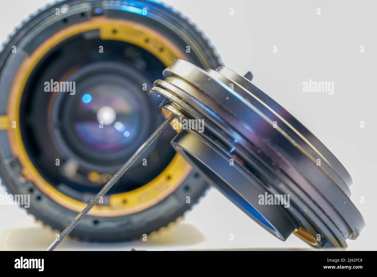 Clean and disassemble the lens for photography into its component parts ...