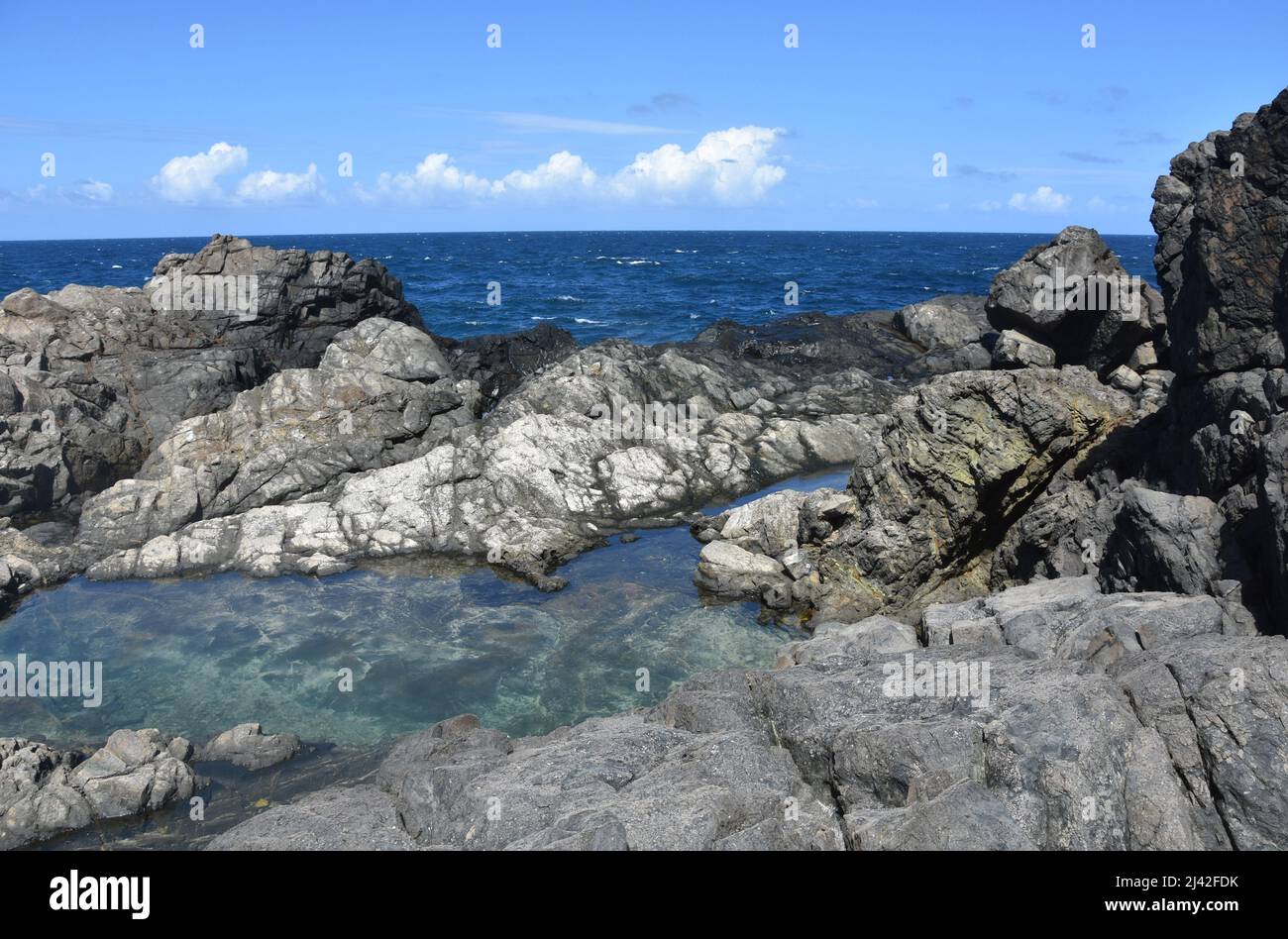 Stunning rugged rocky cove with a shallow water natural pool in Aruba ...