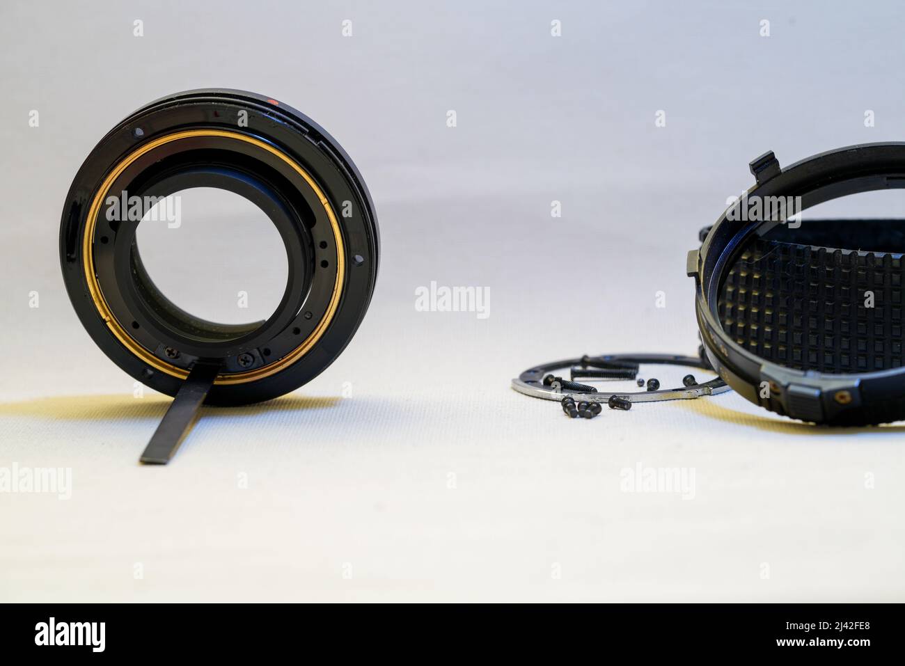 Clean and disassemble the lens for photography into its component parts ...