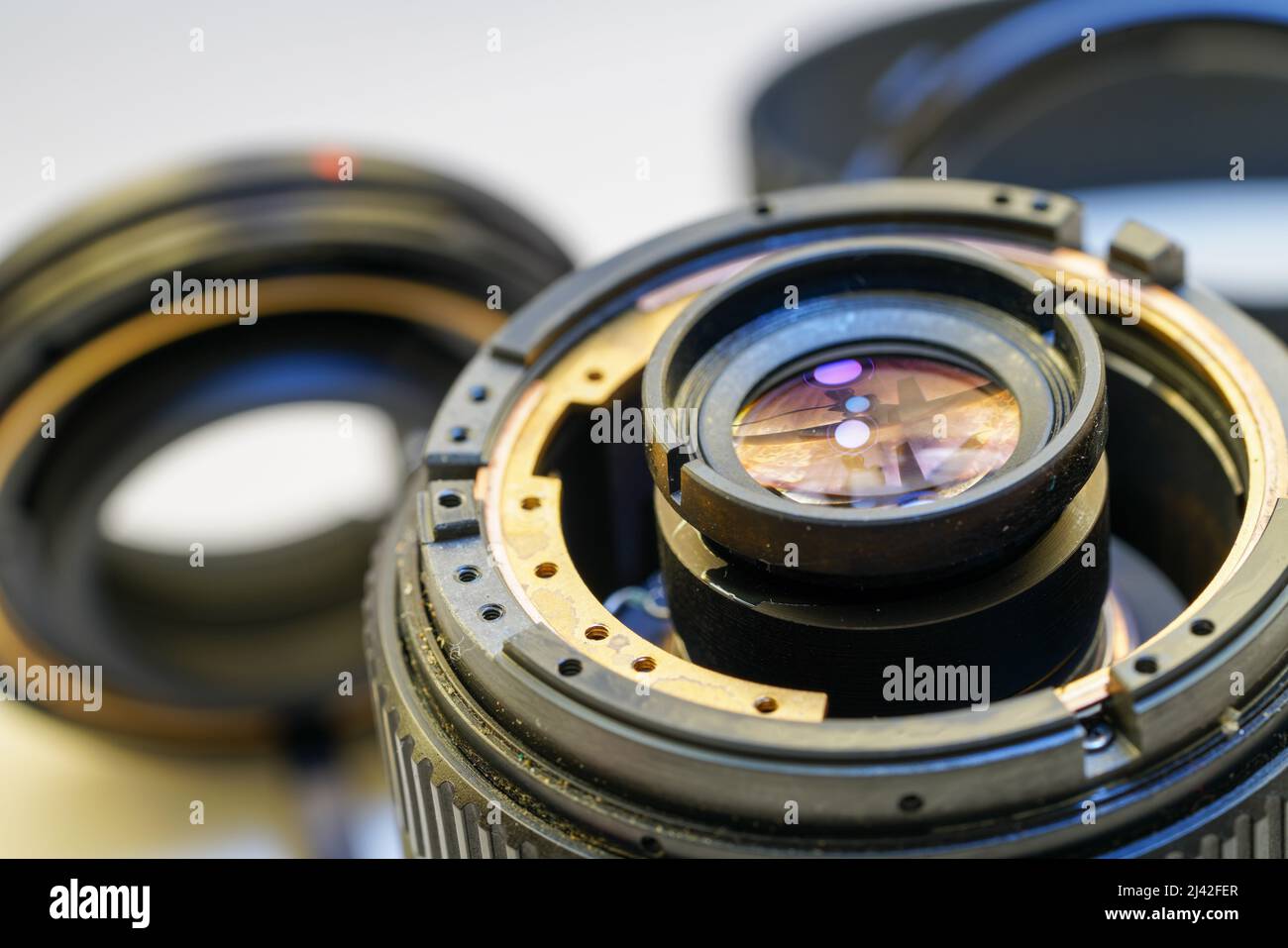 Clean and disassemble the lens for photography into its component parts ...