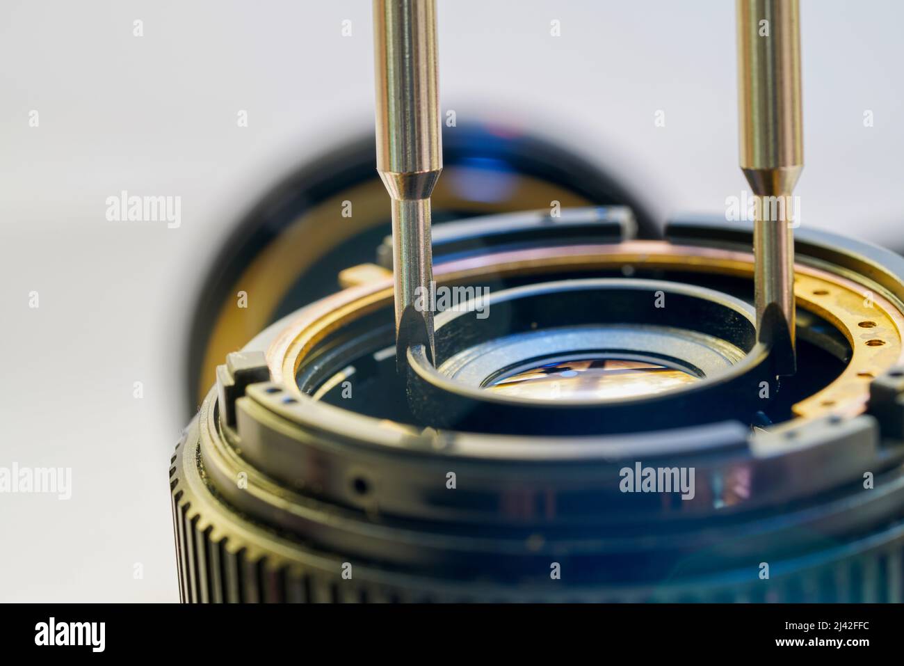 Clean and disassemble the lens for photography into its component parts ...