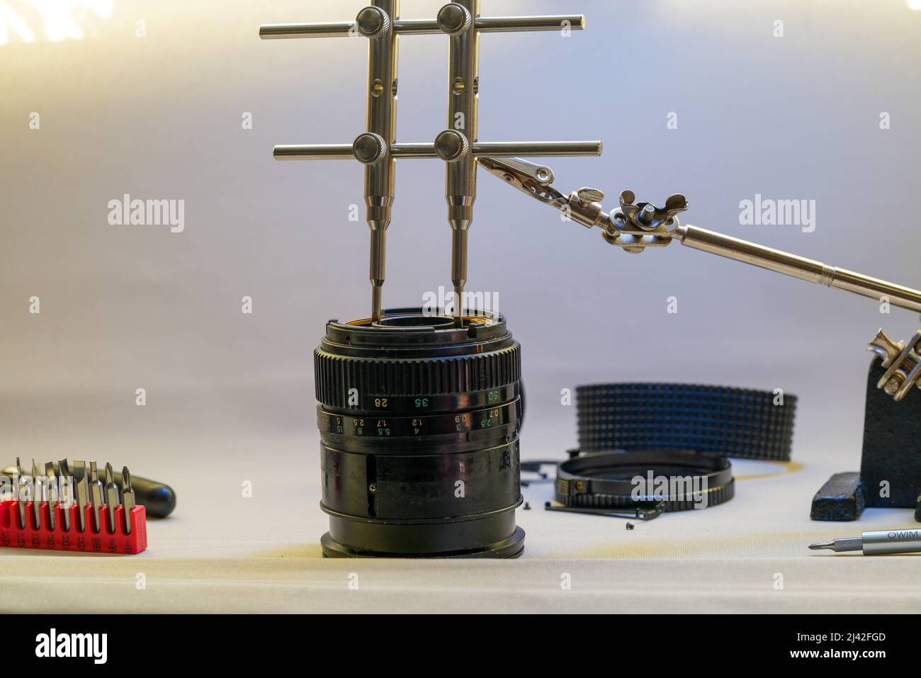 Clean and disassemble the lens for photography into its component parts ...