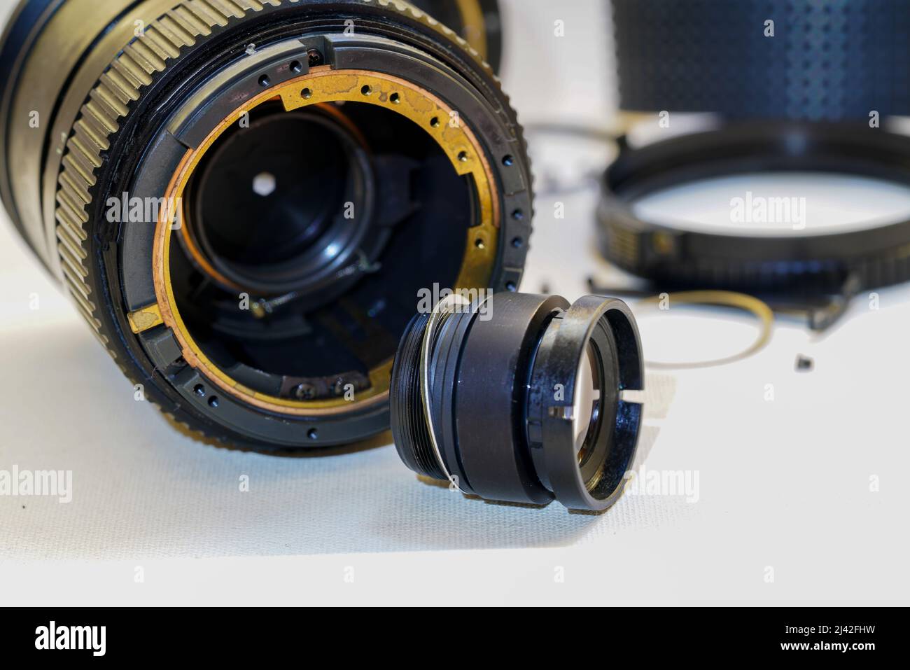 Clean and disassemble the lens for photography into its component parts ...