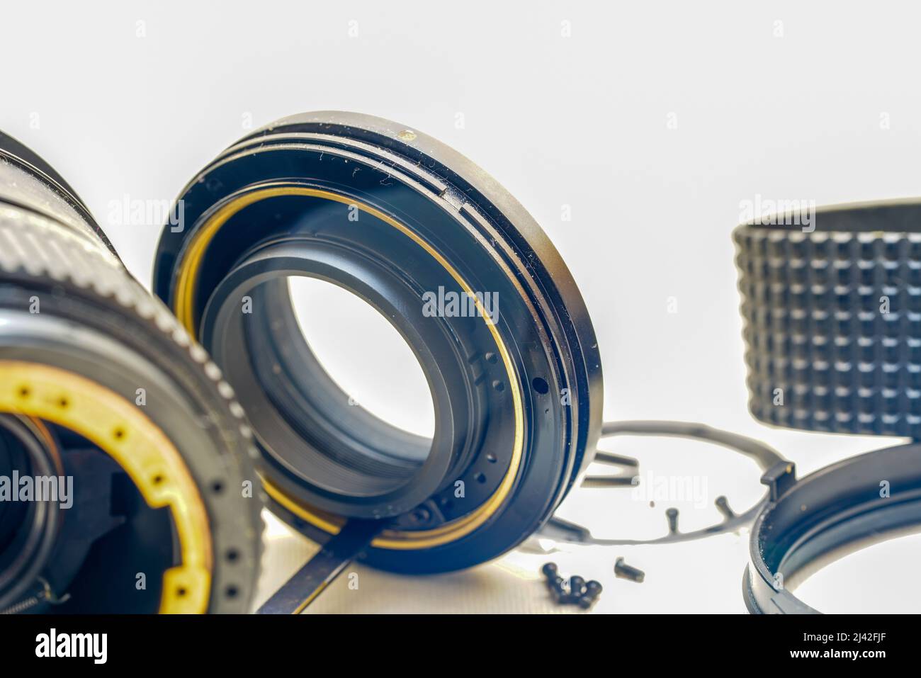 Clean and disassemble the lens for photography into its component parts ...