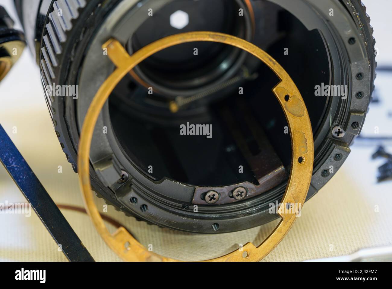 Clean and disassemble the lens for photography into its component parts ...