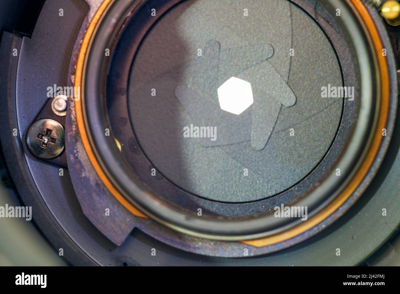 Clean and disassemble the lens for photography into its component parts ...