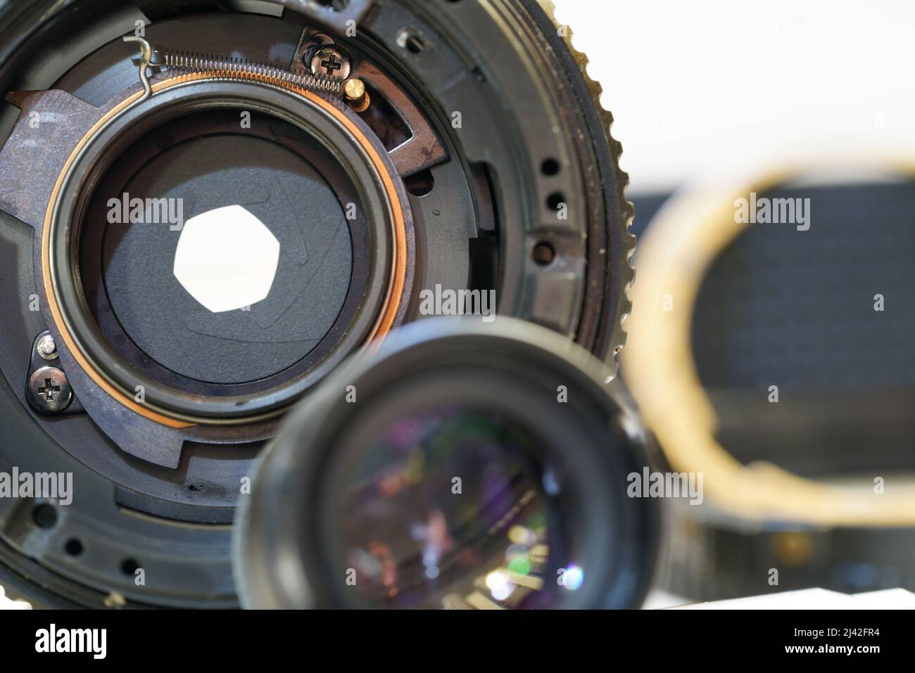 Clean and disassemble the lens for photography into its component parts ...