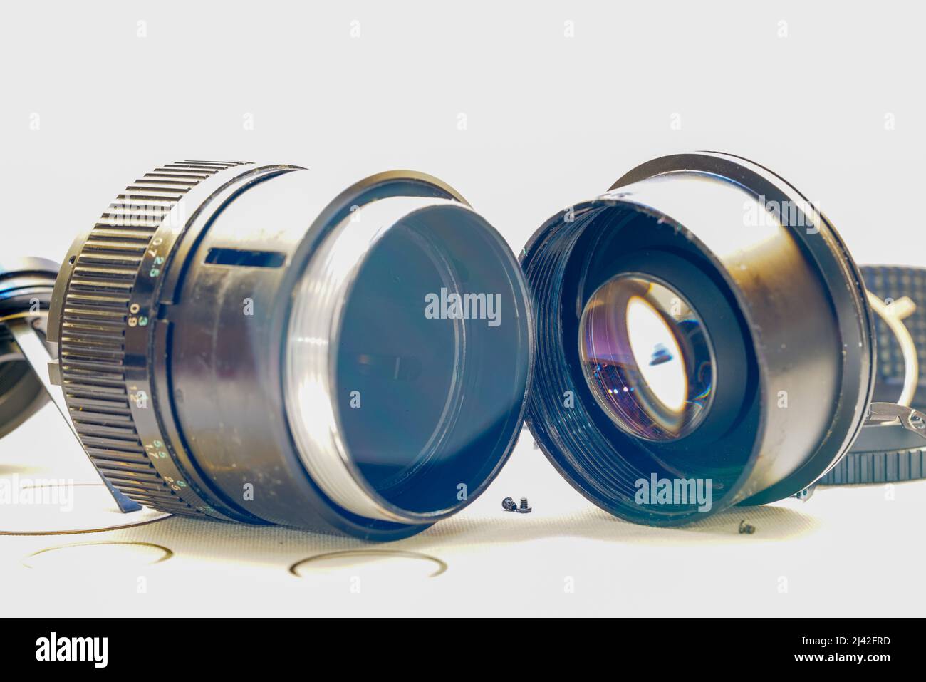 Clean and disassemble the lens for photography into its component parts ...