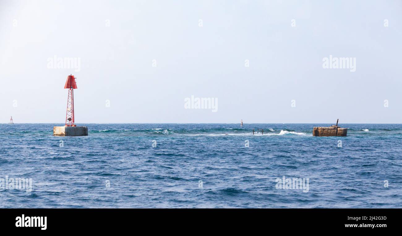 Red beacon tower is on the border of a fairway, framed structure with ...