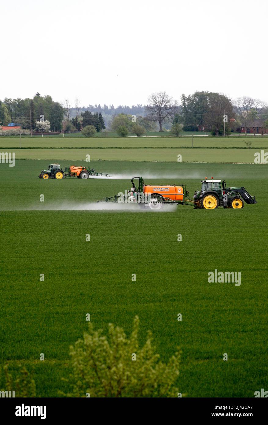 Farmers spraying their fields Stock Photo - Alamy