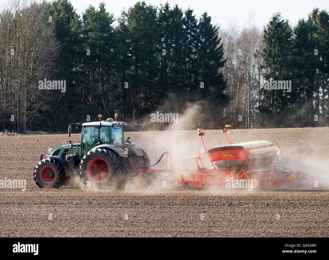 Farmers with tractors sowing their fields Stock Photo - Alamy