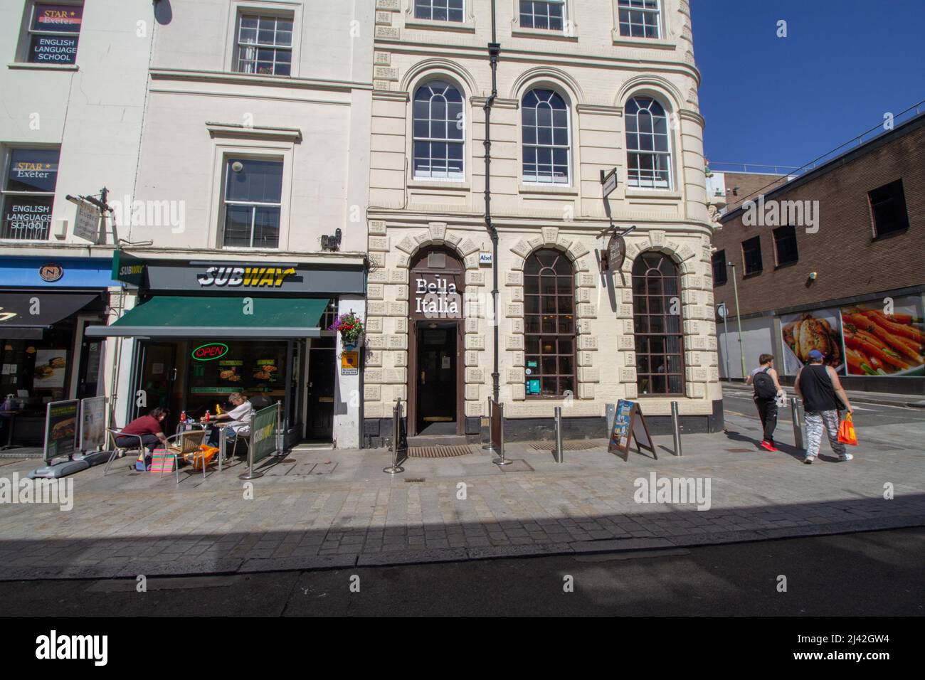 EXETER, UK - JULY 18, 2021 Queen Street shops and shoppers Stock Photo ...
