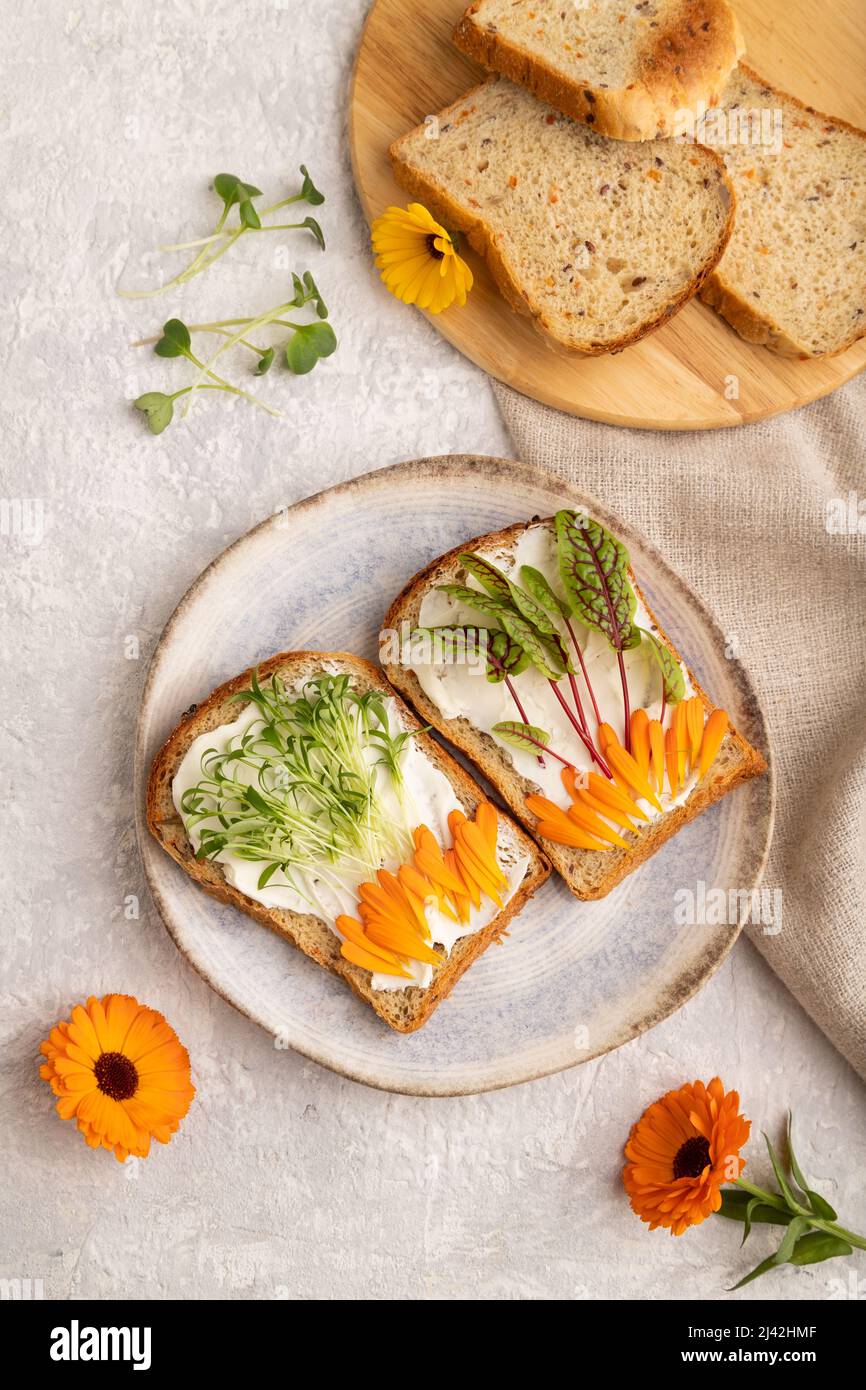 White bread sandwiches with cream cheese, calendula petals and ...