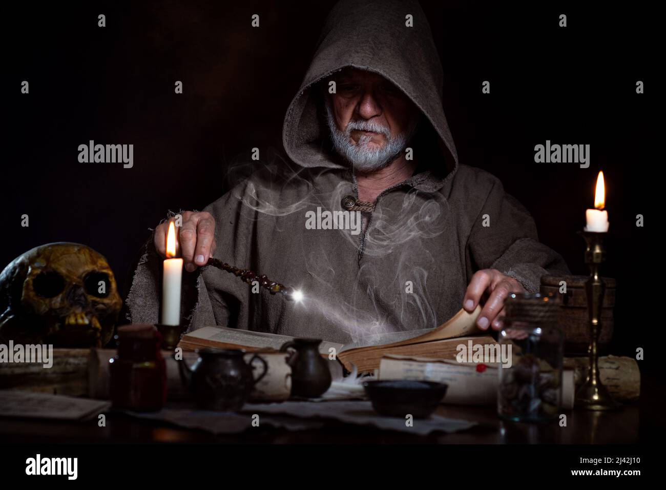 Merlin performs magic with a magic wand Stock Photo - Alamy