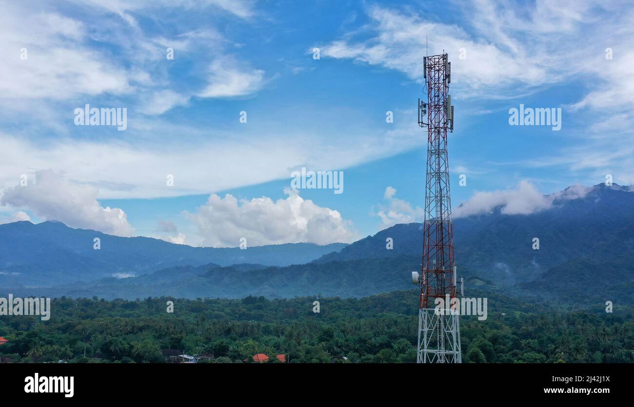 Aerial view of 4G and 5G Telecom Tower on the top of hill covered of ...