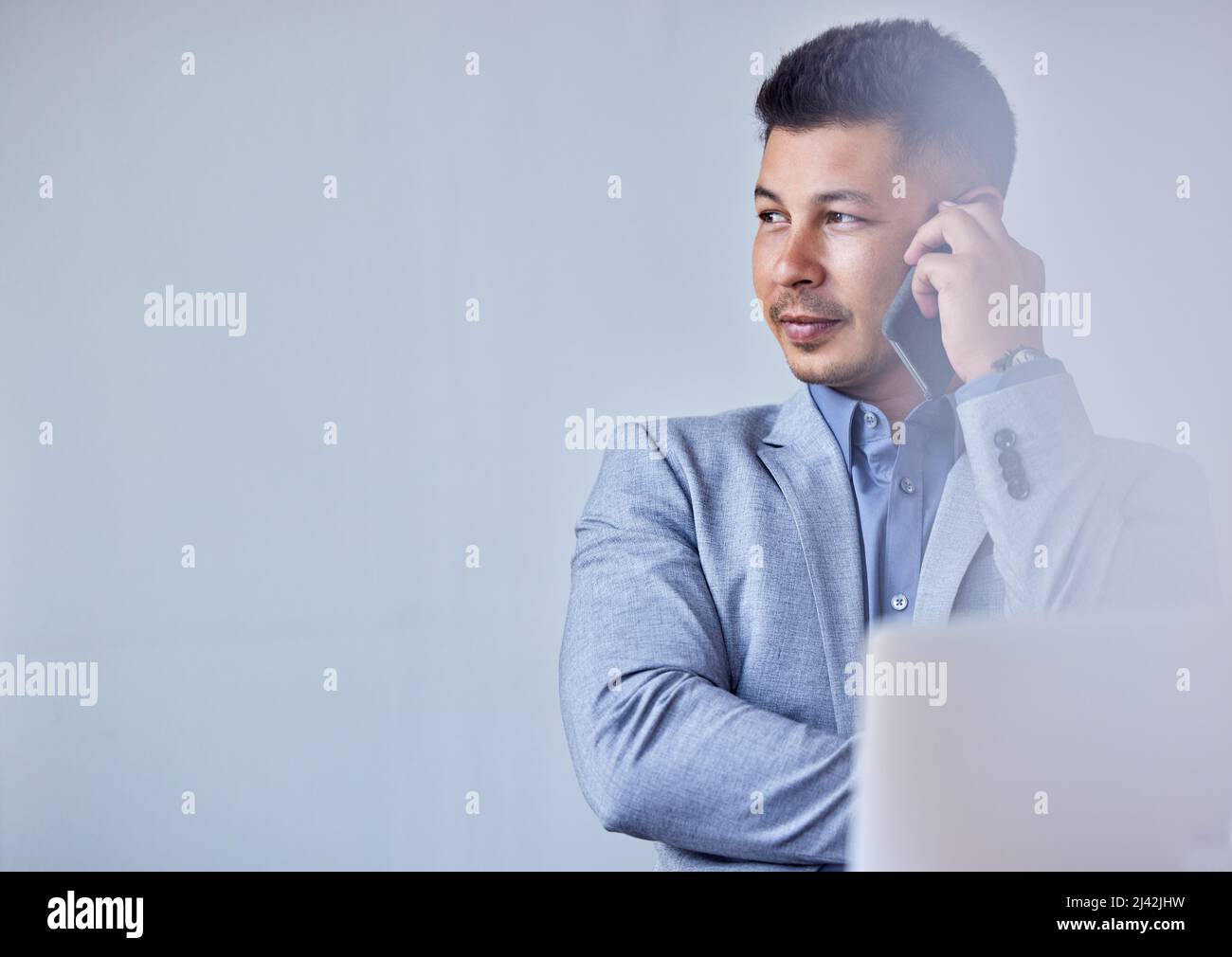 This is an important call. Shot of a young businessman using his ...