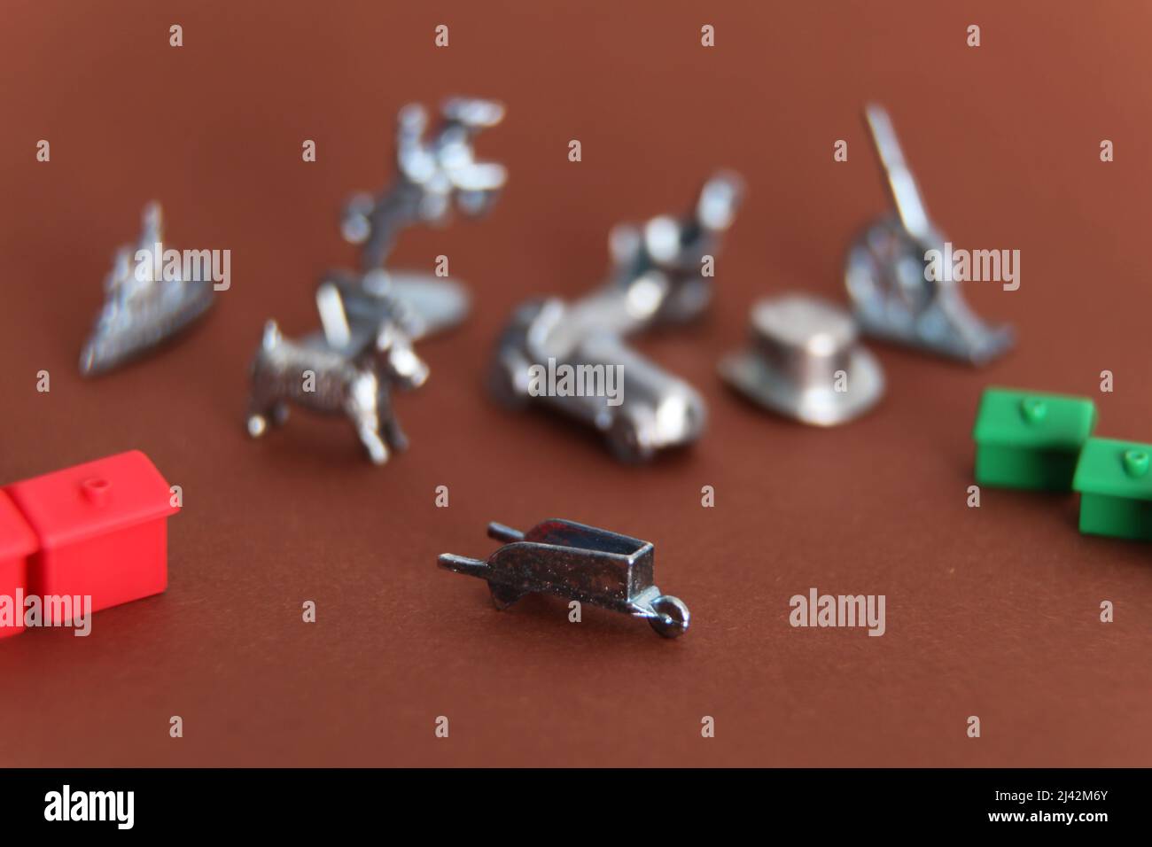 Monopoly games pieces with 1 wheelbarrow icon piece in focus and other ...