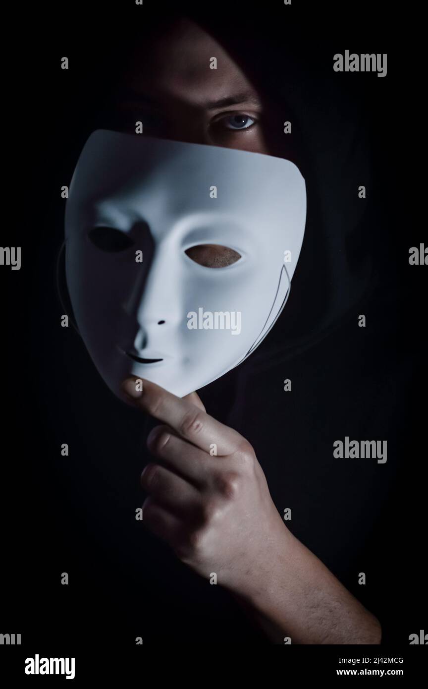 Take off the mask - Portrait of a young hooded man who takes off his ...