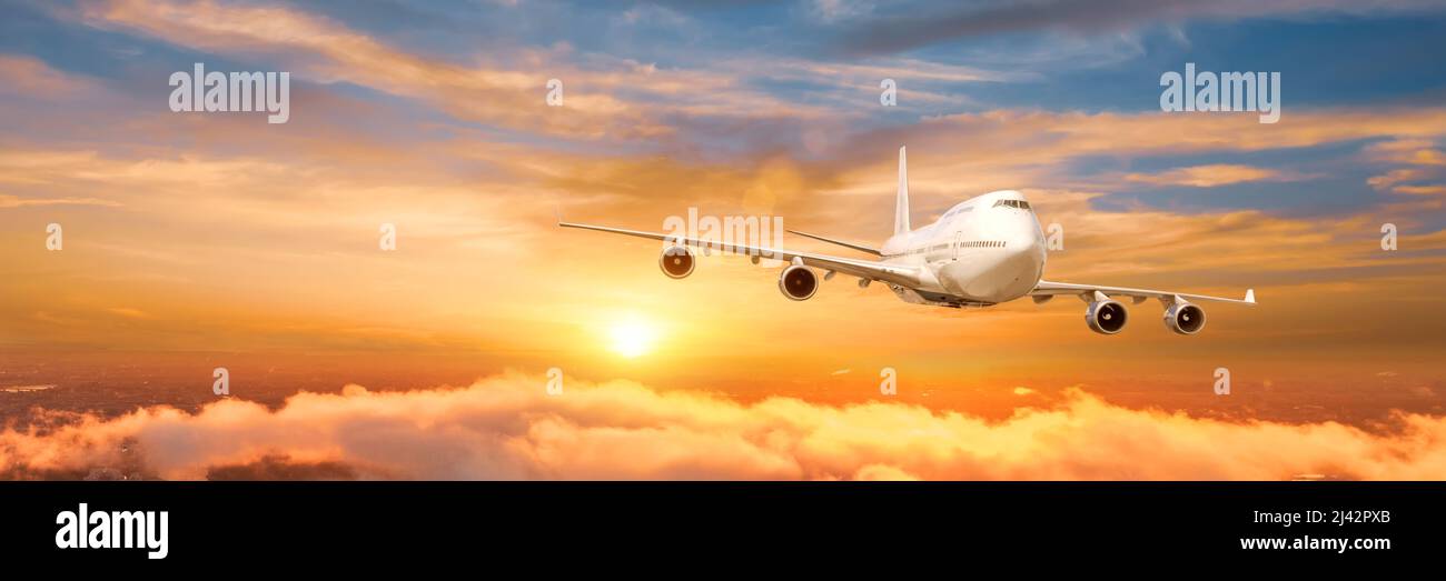 Wide panoramic view, banner of a flying passenger airplane four jet ...